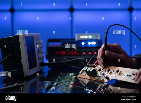 Debugging Electronics Device PCB Witch Microcontroller In Electronics Laboratory Stock Photo
