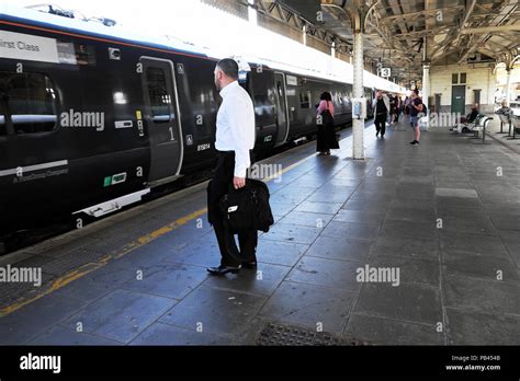 Business Man Standing On Platform Preparing To Board First Class