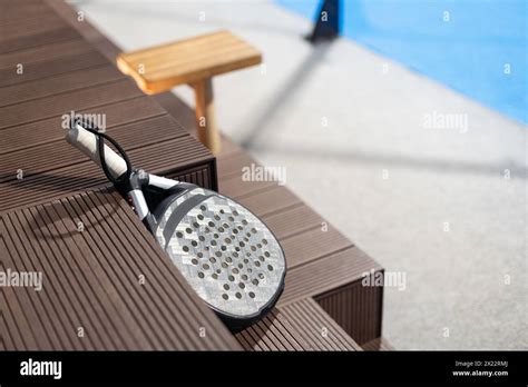 Paddle Tennis Paddel Racket And Ball In Front Of An Outdoor Court