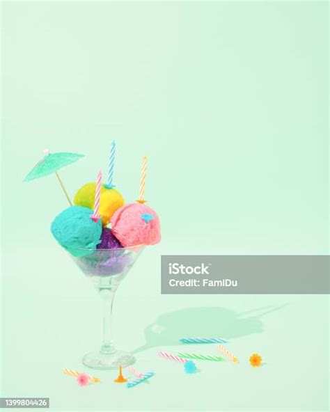 파스텔 녹색 배경에 아이스크림과 양초의 다채로운 스쿱으로 만든 창조적 인 개념 최소한의 여름 개념 축하 케이크 및 생일 영감