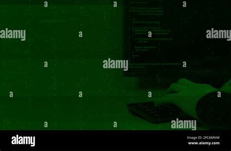 Green Background Programmer Hands Close Up Typing Code On Keyboard