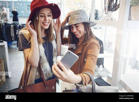 Im Lovin This Hat Two Young Girlfriends Snapping Selfies While Out On