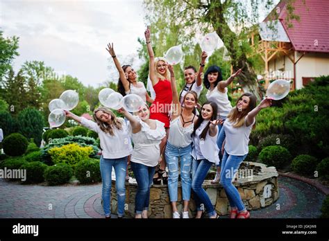 Comany Of Young Women Posing Outside With Inflated Condoms At