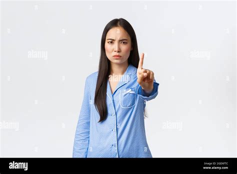 Disappointed Serious And Angry Asian Woman In Blue Pajamas Shaking