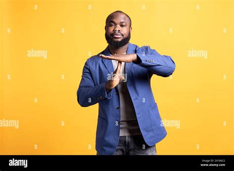 Portrait Of Assertive Man Asking For Timeout Doing Hand Gestures
