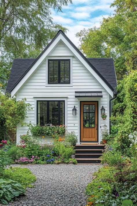 White Cottage With Wooden Door And Colorful Garden Check Out These