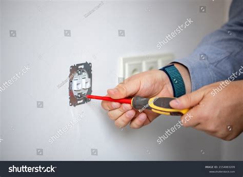 Electrician Installing Electrical Outlet Over 7130 Royalty Free