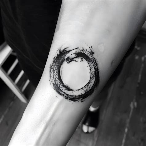 A Tattoo On A Womans Arm With A Ring That Says Quot The Symbol Of A