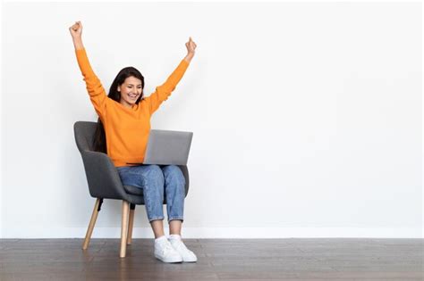 Premium Photo Thrilled Millennial Hindu Woman Looking At Laptop