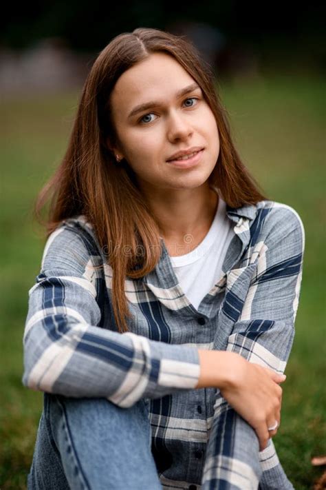 Portrait Of Young Blue Eyed Woman With Brown Hair In Plaid Shirt Stock