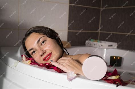 Premium Photo Young Smiling Brunette Woman Taking A Bath With Rose