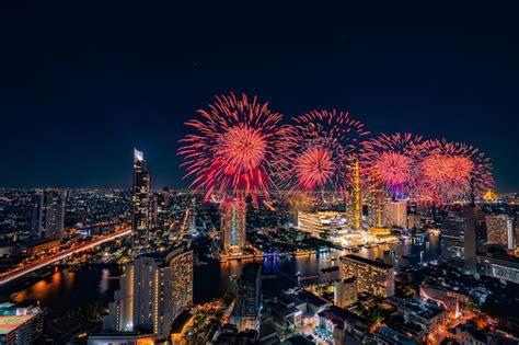 Premium Photo Red Firework Display Over City Lit Up At Night High