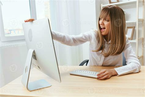 Angry Evil Blonde Businesswoman Screaming To Desktop Raging After