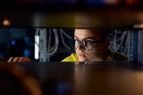 Young Woman It Engineer Working In Datacenter Room Connecting Cables