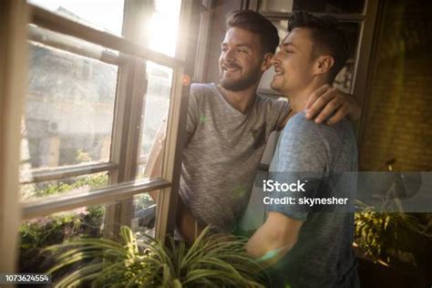 Embraced Gay Men Enjoying In Their Time While Looking Through Window