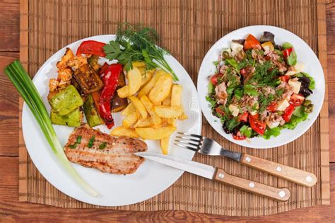 Grilled Boneless Pork Chop With Baked Vegetables And Tuna Salad Stock