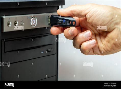 Hand Inserting A Usb Flash Drive Into A Computer Stock Photo Alamy