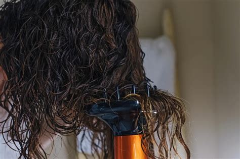 Premium Photo Woman Diffusing Her Hair With Dryer Drying Hair