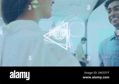 Animation Of Geometric Figures Spinning Over Man And Woman Talking Global Business Digital