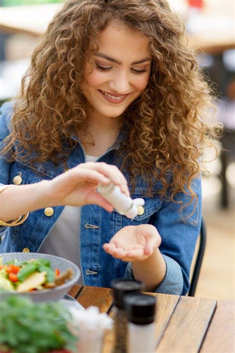 Beautiful Woman Sanitizing Her Hands With Disinfectant Gel In A