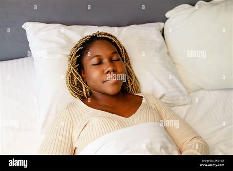Afro American Female Keeping Eyes Closed While Sleeping At The Bedroom
