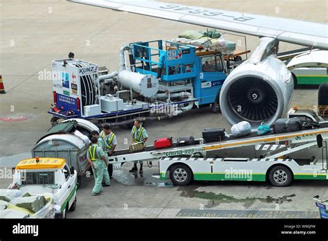 Passengers Lugguge Are Pictured As Being Offloaded From A Plane At Shanghai Pudong International