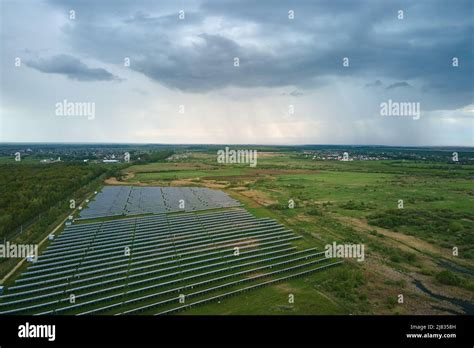 Aerial View Of Big Sustainable Electric Power Plant With Many Rows Of Solar Photovoltaic Panels