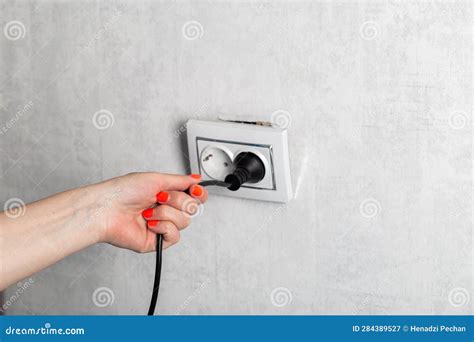 The Girl Incorrectly Removes The Electric Plug From The Socket And Breaks The Socket Danger Of