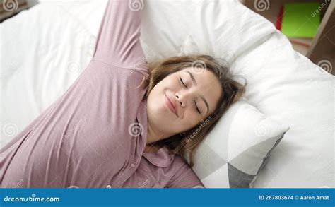 Young Beautiful Hispanic Woman Lying On Bed Sleeping At Bedroom Stock