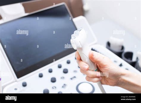 Woman Doctors Hand Aholding A Medical Gel To Ultrasonic Sensor Of The Ultrasound Machine In The