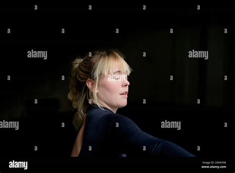 Eyes Closed Arms Stretched Behind Back Peaceful Posture Dark Background