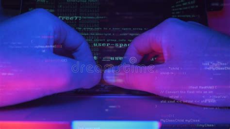 Male Hacker Is Working On Laptop Computer Keyboard With Graphic User