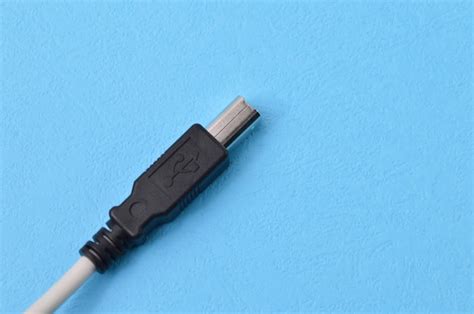 Premium Photo Close Up View Of Usb Cable For Printer Isolated On A Blue Background