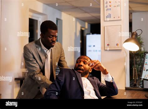 Tired Exhausted Employee Falling Asleep On Desk After Working Overtime