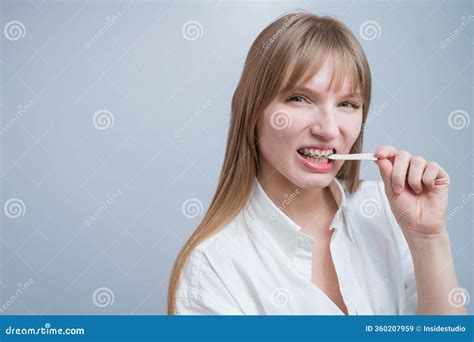 Young Woman With Metal Braces On Her Teeth Is Chewing Gum The Girl Is