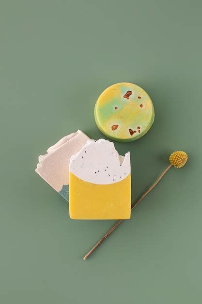 Premium Photo Pieces Of Different Shapes And Colors Of Handmade Soap On A Green Background