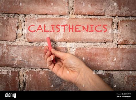 Calisthenics Text Written With Red Chalk On A Red Brick Background
