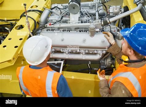 Workers Inspecting Power Unit Stock Photo Alamy