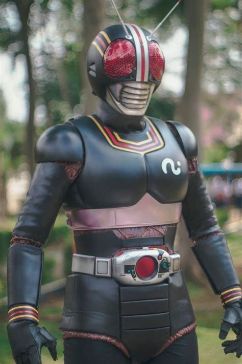 A Man In A Black Suit And Red Helmet