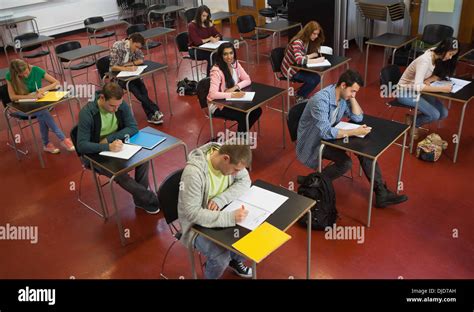 Babes Taking Notes In Class With One Girl Smiling Up At Camera Stock Photo Alamy