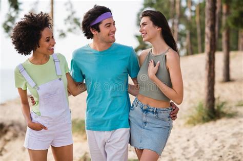 Photo Of Three Cheerful Peaceful People Cuddle Embrace Chatting