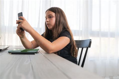 Schoolkid Spending Too Much Time On Mobile Device Stock Photo Image