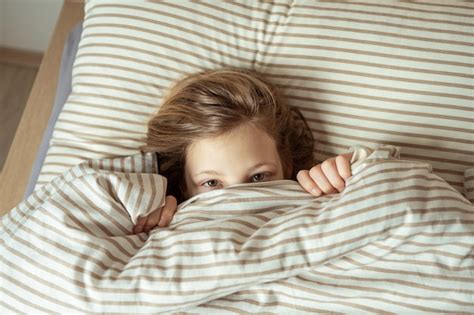 Premium Photo Portrait Of Girl Lying On Bed At Home