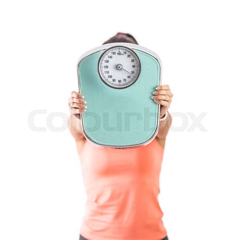 Woman Holds A Weighing Scale Against The Camera Covering Her Face With It Stock Image Colourbox