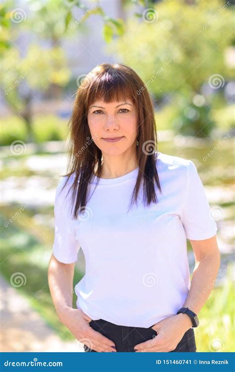 Beautiful Middle Aged Woman Smiling Friendly And Looking In Camera In
