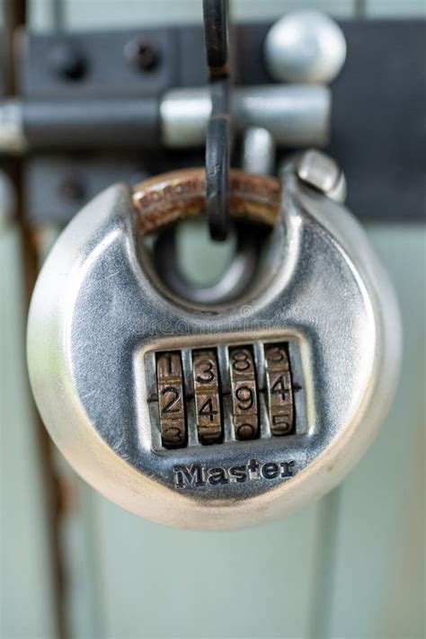 Vertical Closeup Shot Of Rusty Metal Lock With Passcode Numbers Hung On
