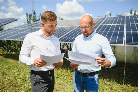Premium Photo Two Engineers Are Conducting Outdoor Inspection Of Solar Photovoltaic Panels