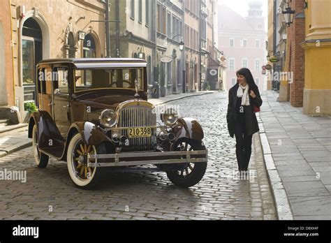Oldtimer Car Essex Super Six And Young Woman On Old Town In Warsaw