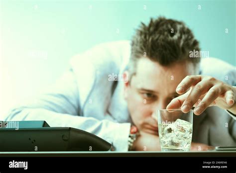 Overwhelmed By Stress A Man Resorts To Drinking At Work Showing