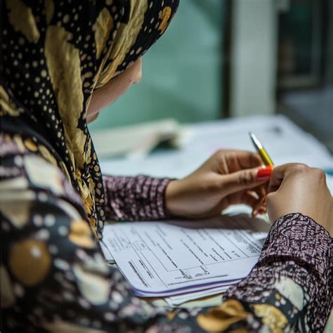 Asylum Seeker Filling Out An Application Form At A Refugee Assistance